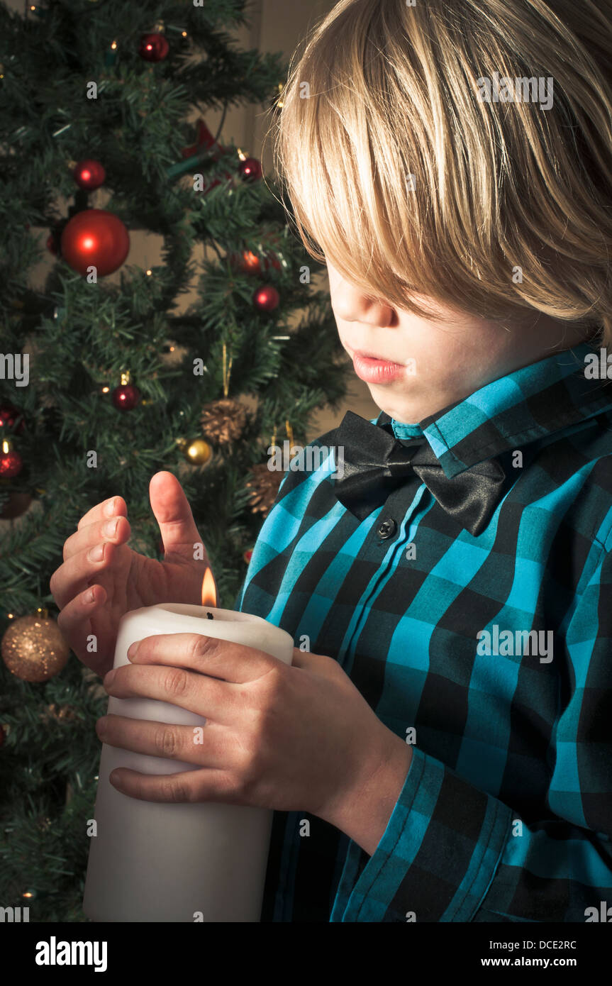 Christmas candle and boy Stock Photo - Alamy