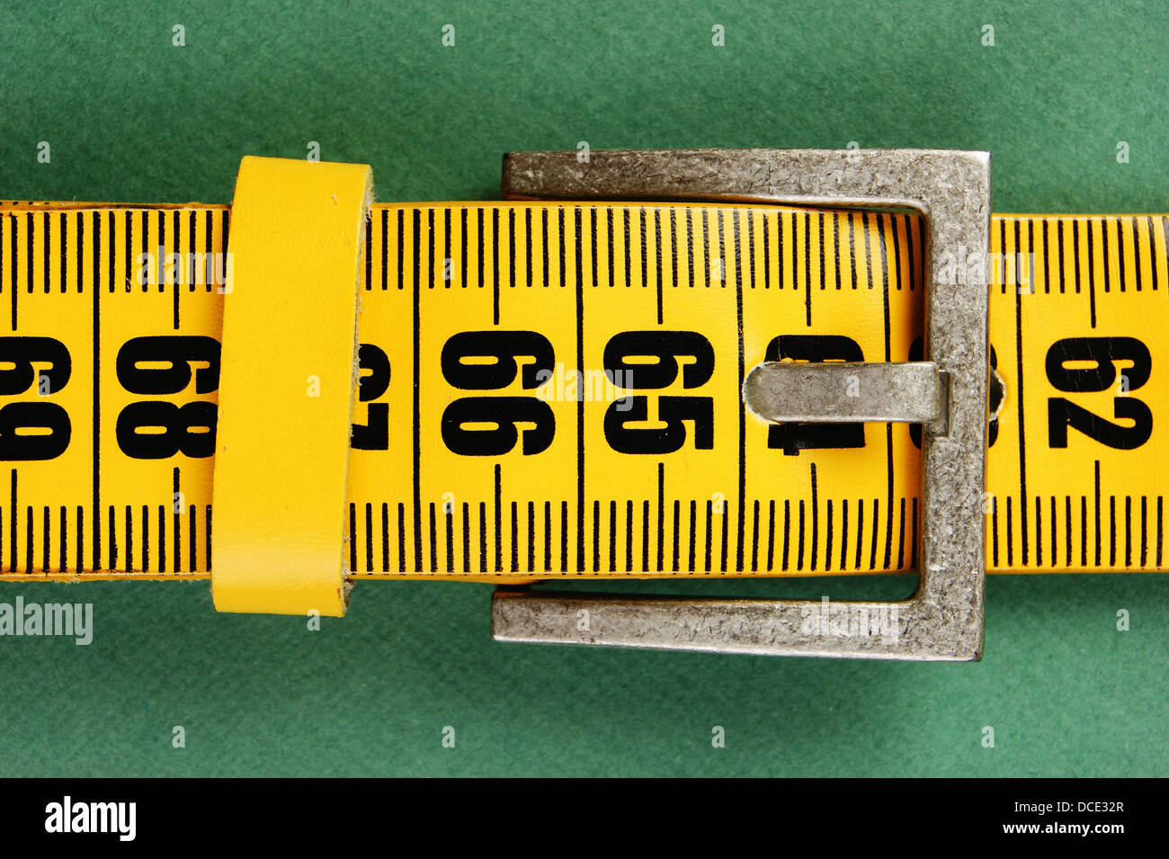 meter belt slimming on the green background Stock Photo - Alamy