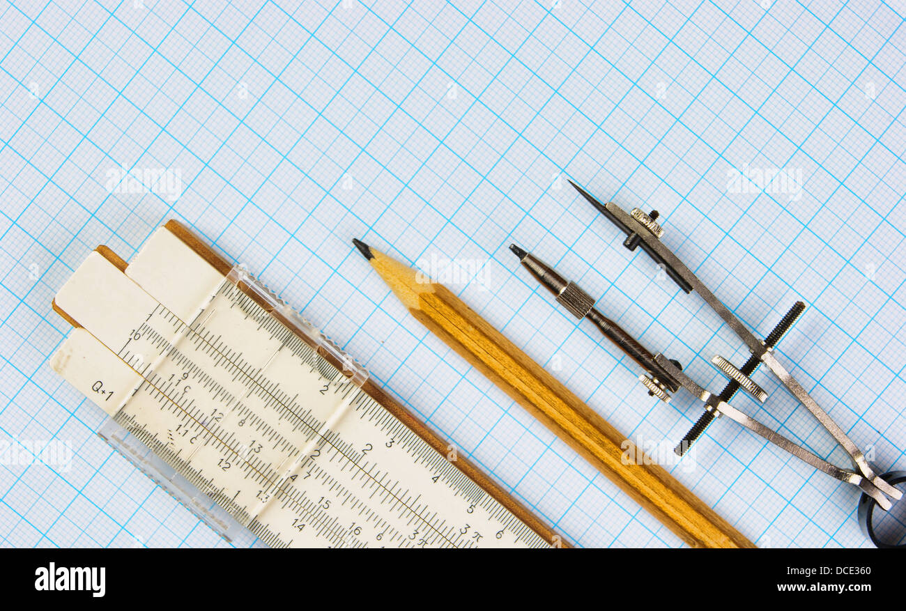 Old drawing tools on graph paper Stock Photo - Alamy