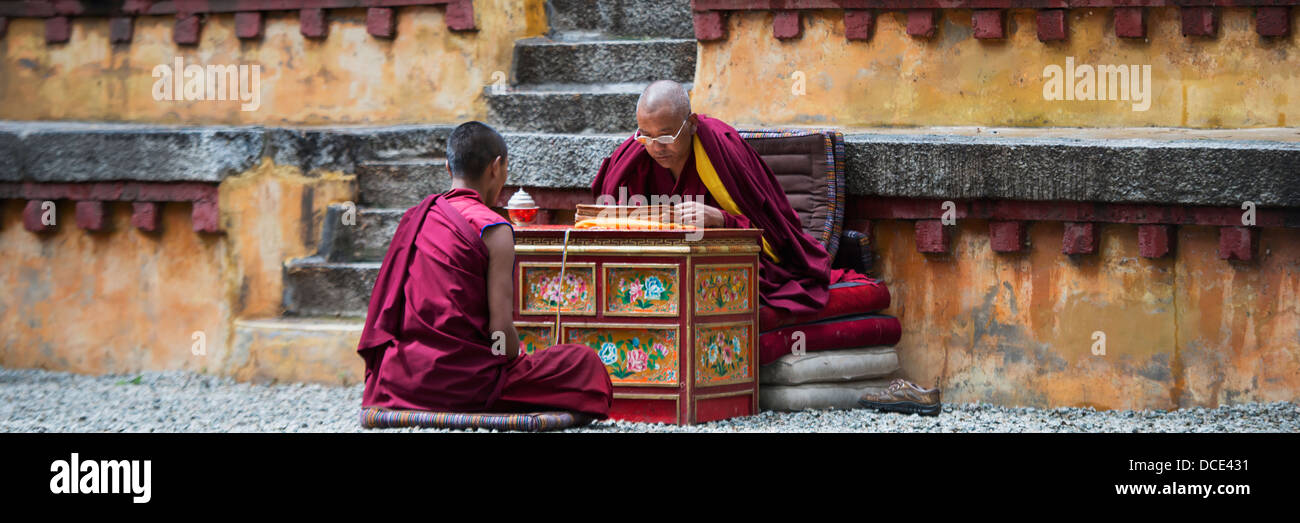 Two Monks sitting together inside Walls of Sera Monastery; Lhasa, Tibet ...