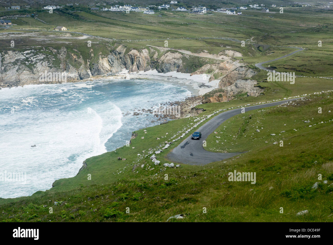 Atlantic Drive car on scenic coastal road with beach and dramatic rough ...