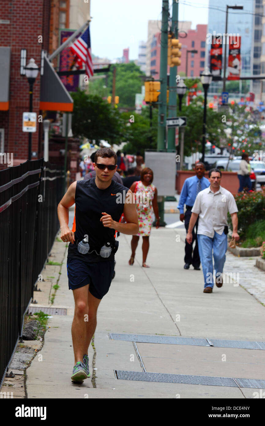 Man running through city streets during lunch break, Baltimore ...