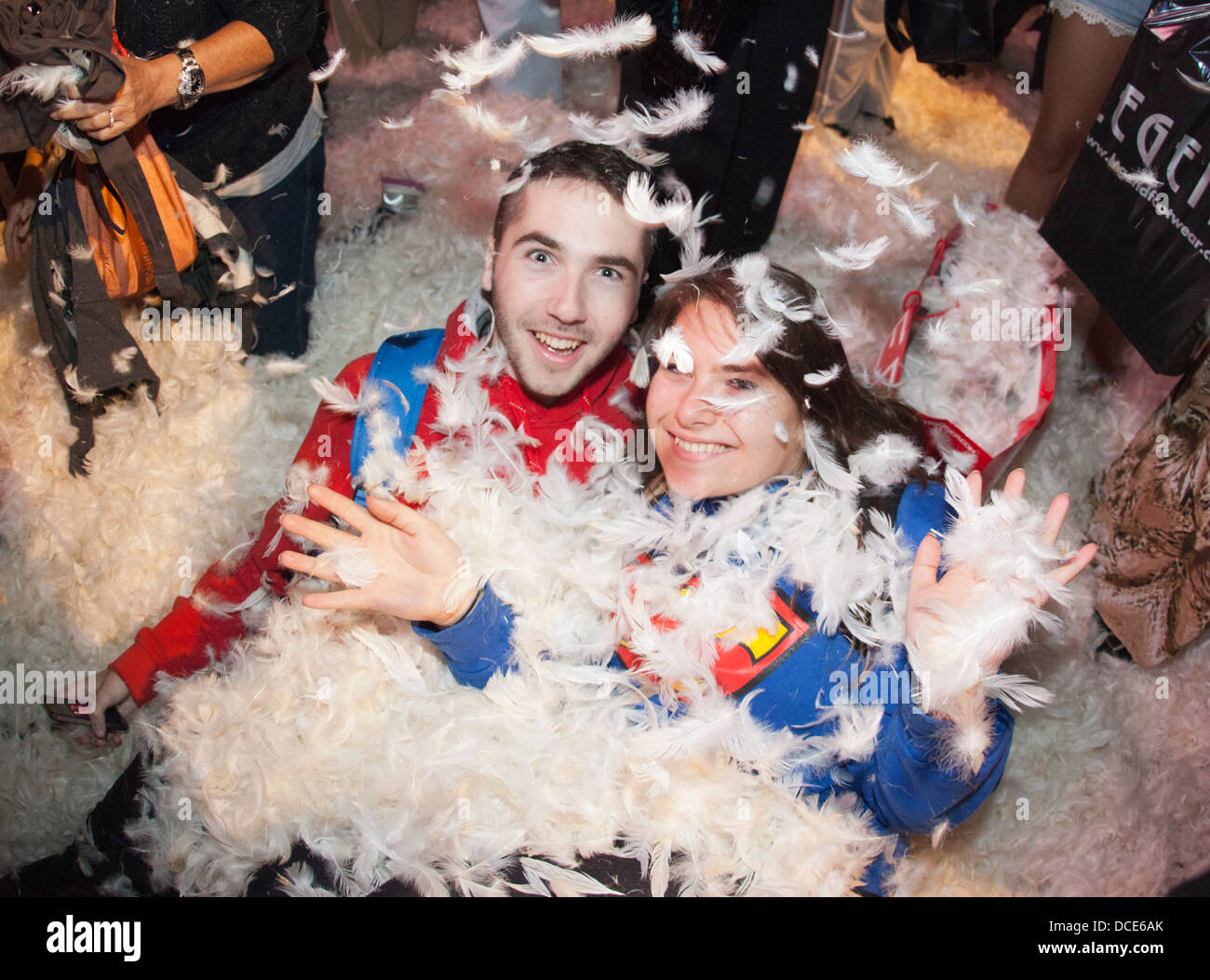 Couple playing with feathers. Les Studios de Cirque presented he UK ...