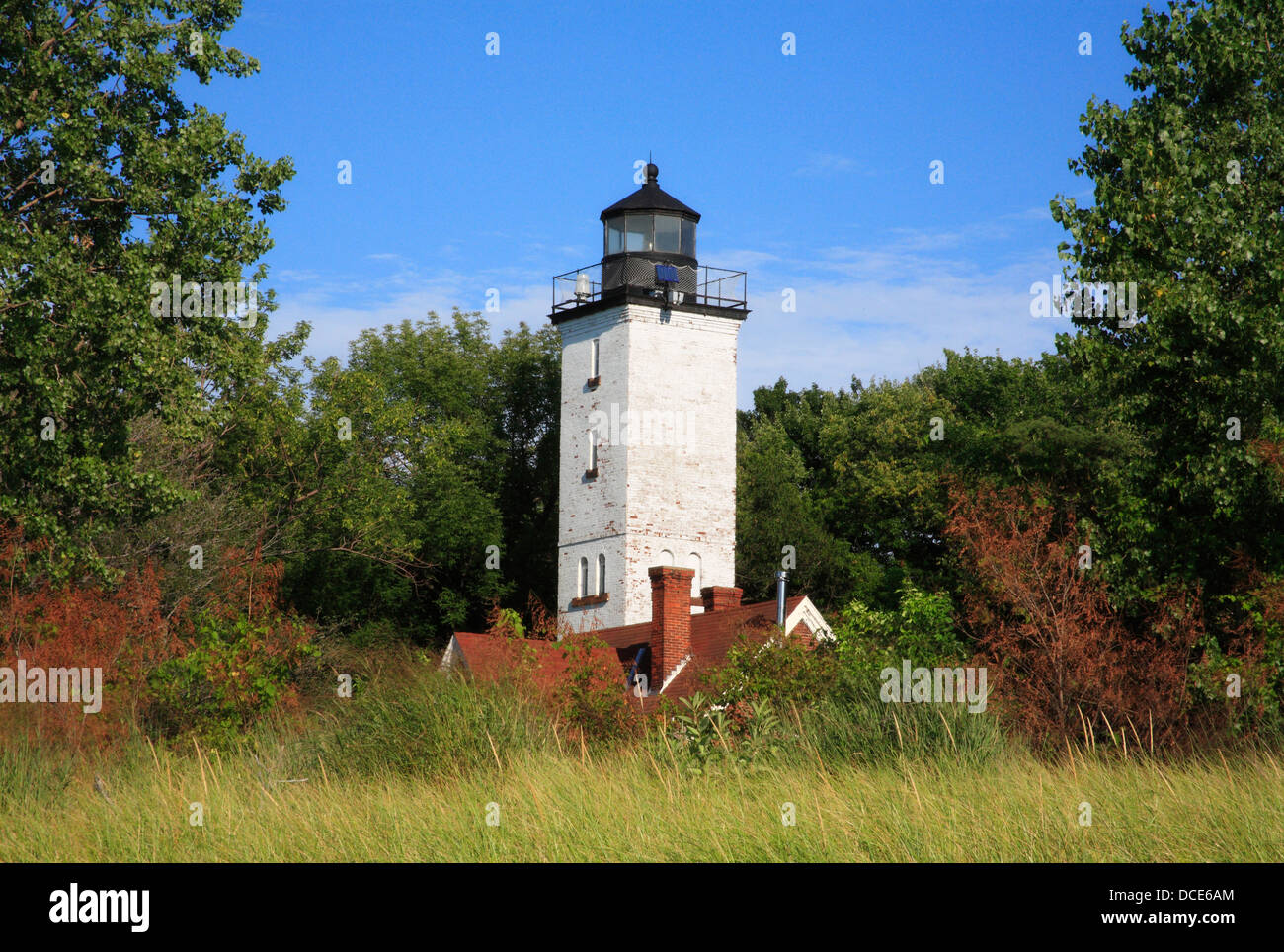 The Presque Isle Lighthouse Tower Rising Above A Sand Dune Covered In ...