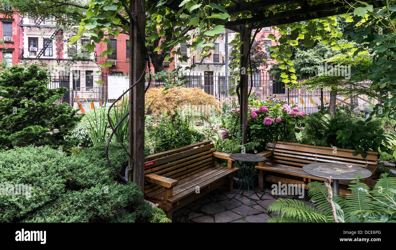 an arbor with seating provides a peaceful place to relax amid greenery ...