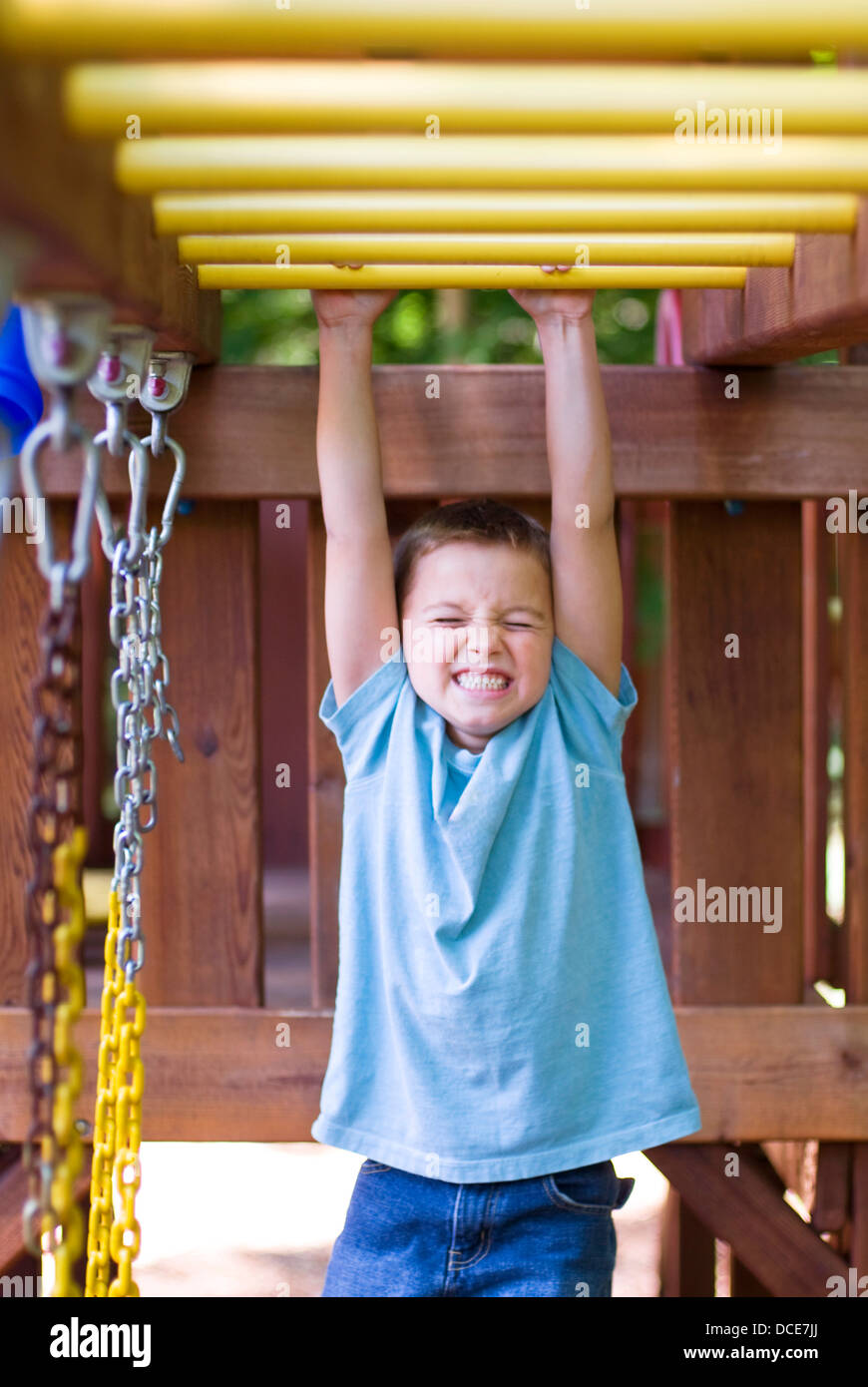 Young Boy Playing On Jungle Gym Swing Set Stock Photo - Alamy