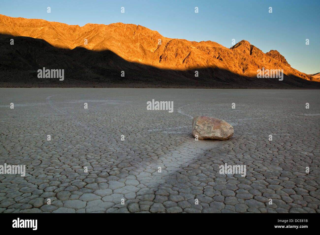 Tracks left by mysterious moving rocks on the dried flat mud at the ...