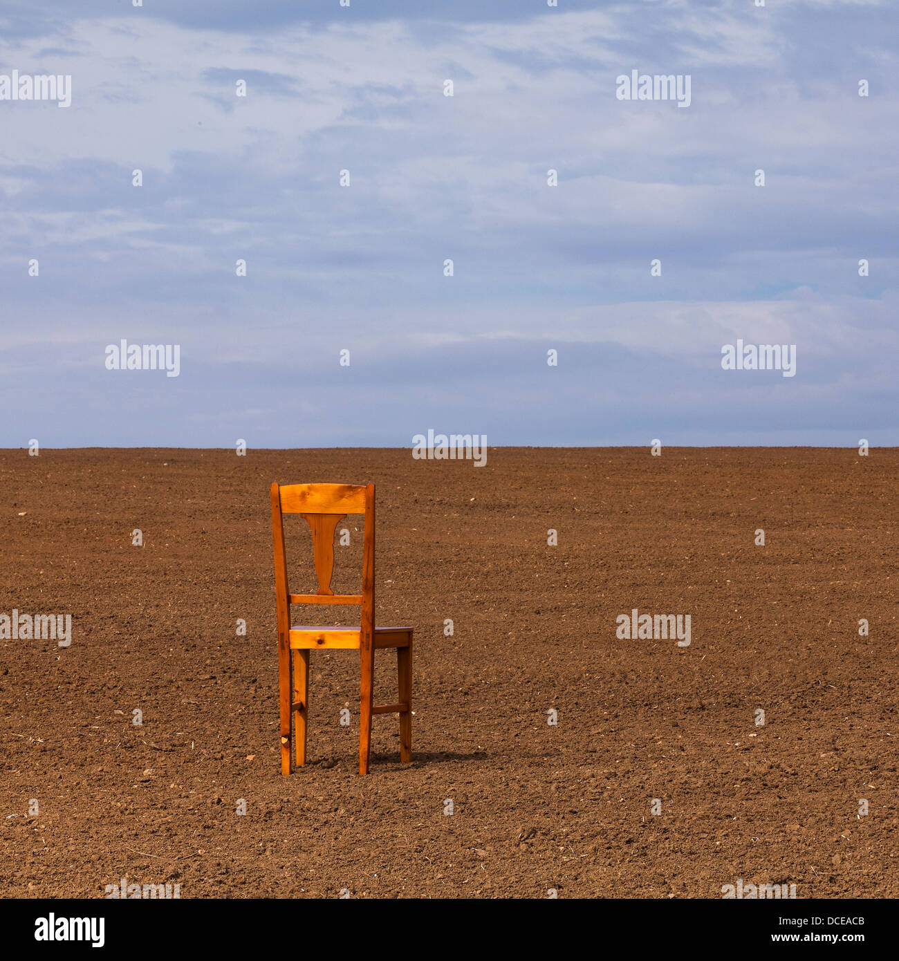 Lonely chair on a cultivated field Stock Photo - Alamy
