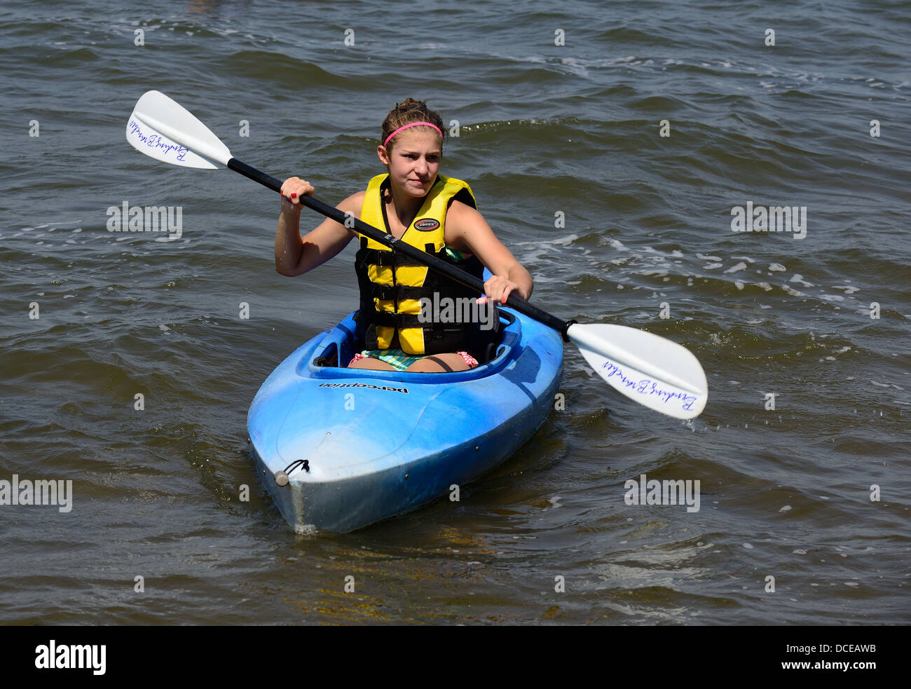 Teen girl paddling on a Kayak Stock Photo - Alamy