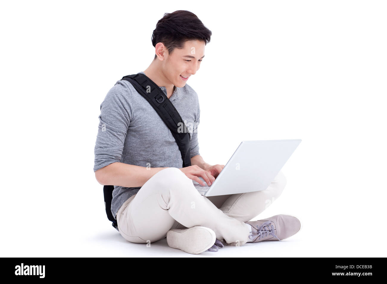Happy male college student using laptop Stock Photo - Alamy