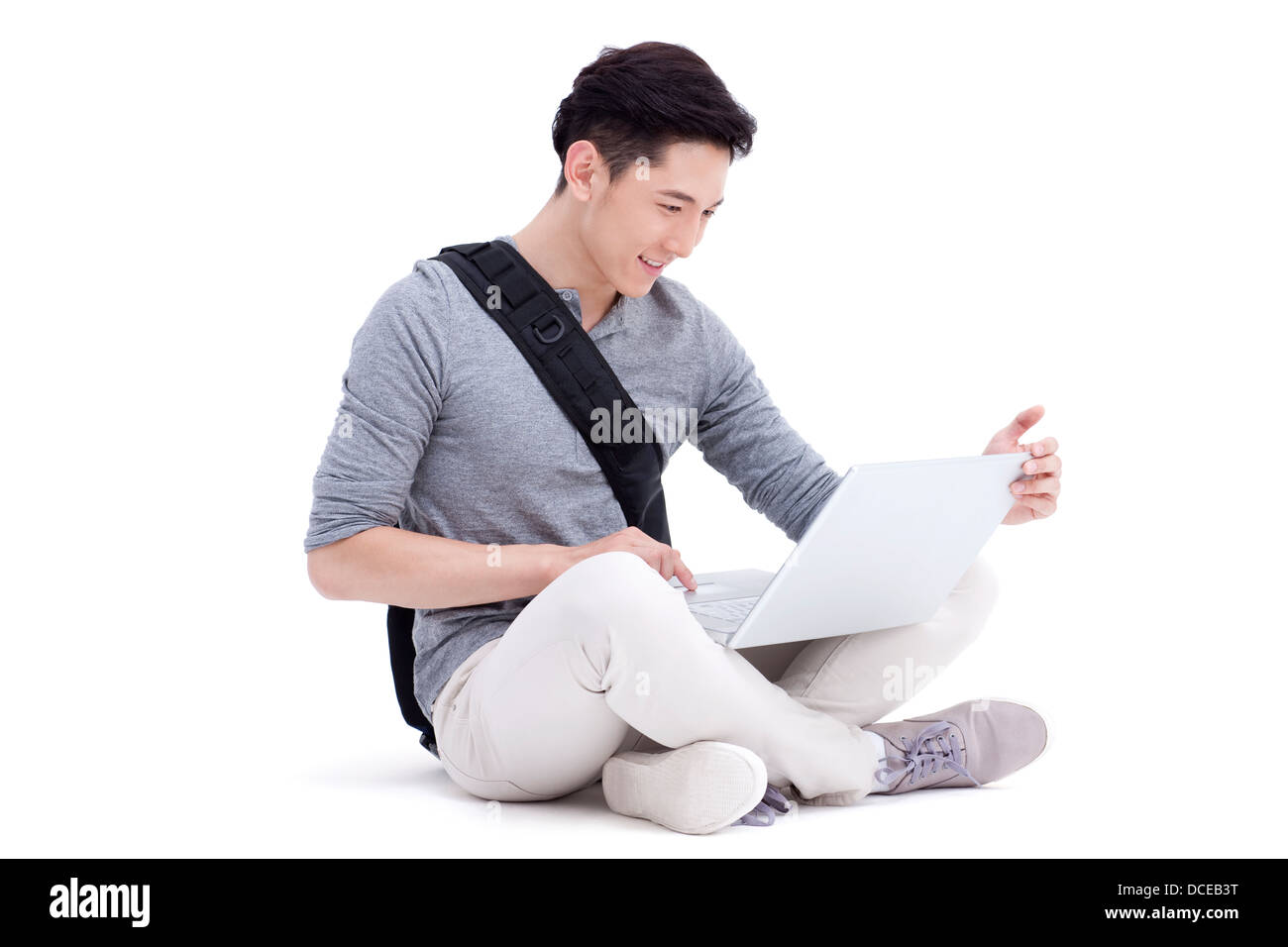 Happy male college student using laptop Stock Photo - Alamy