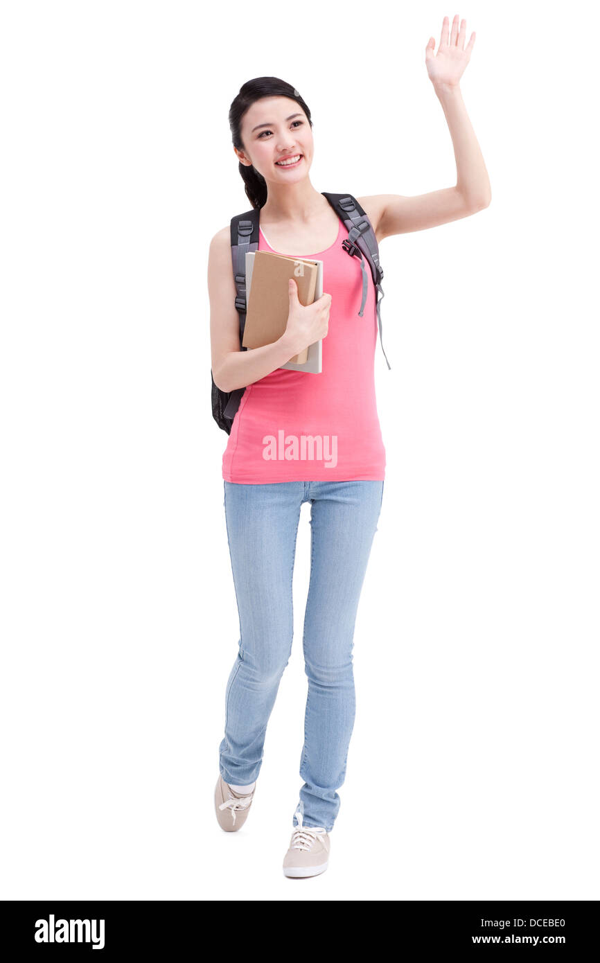 Cheerful college girl waving hand Stock Photo - Alamy