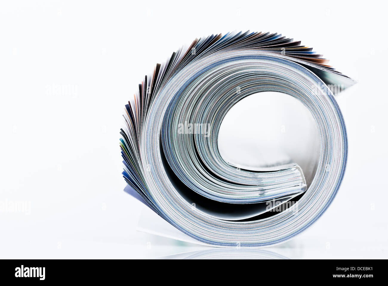 magazine roll on white background Stock Photo - Alamy