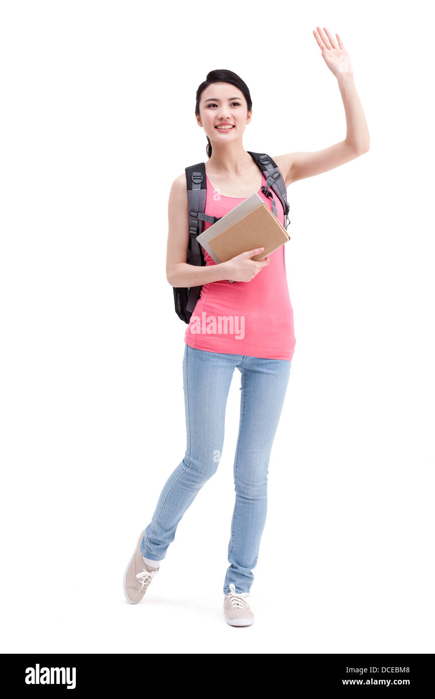 Cheerful college girl waving hand Stock Photo - Alamy