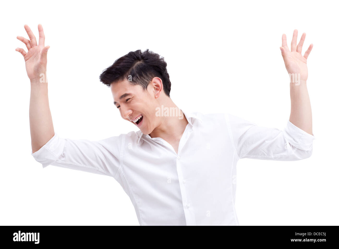 Cheerful young man raising hands Stock Photo - Alamy