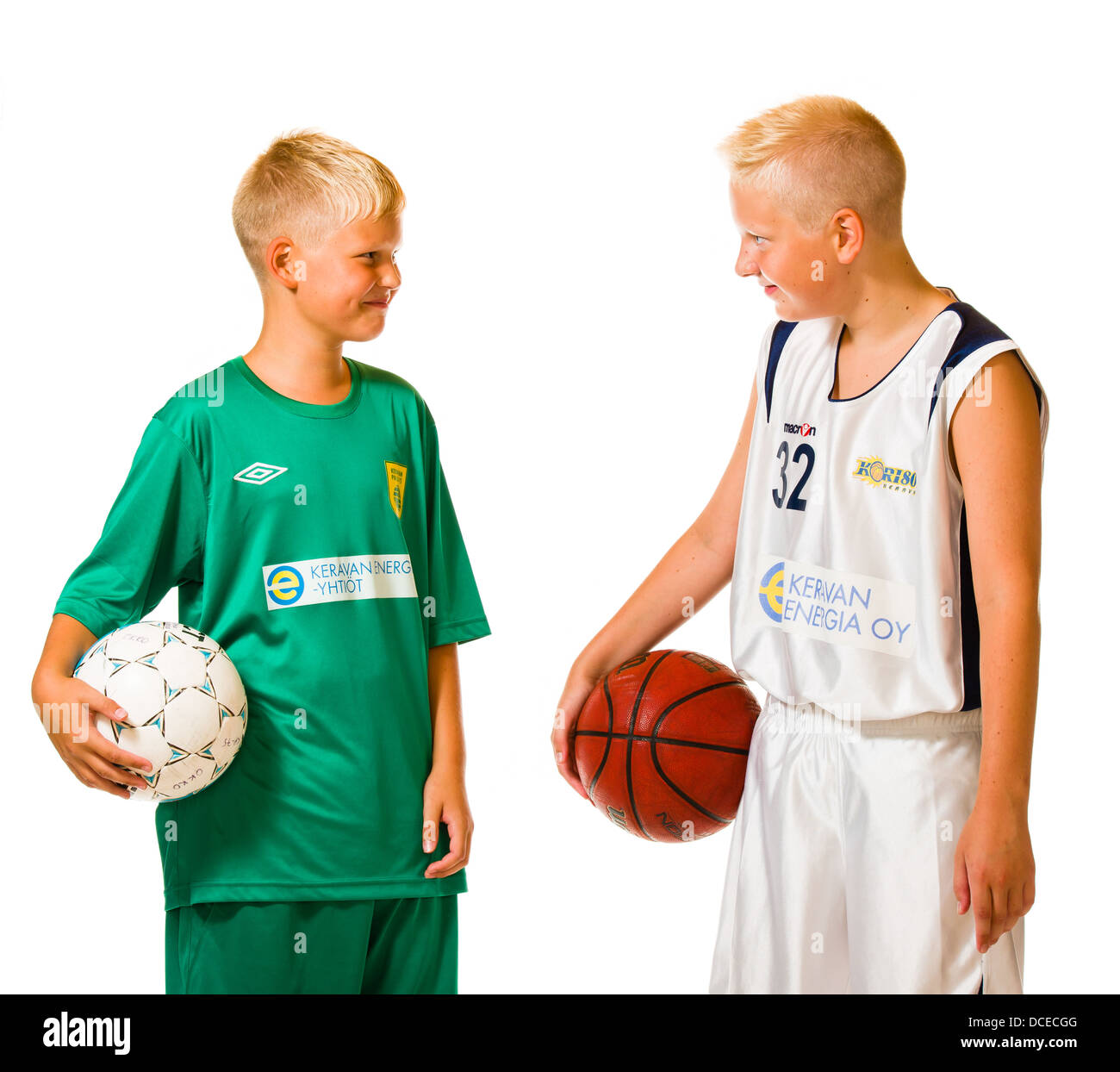 Brothers together, football and basketball player, studio shot, white ...