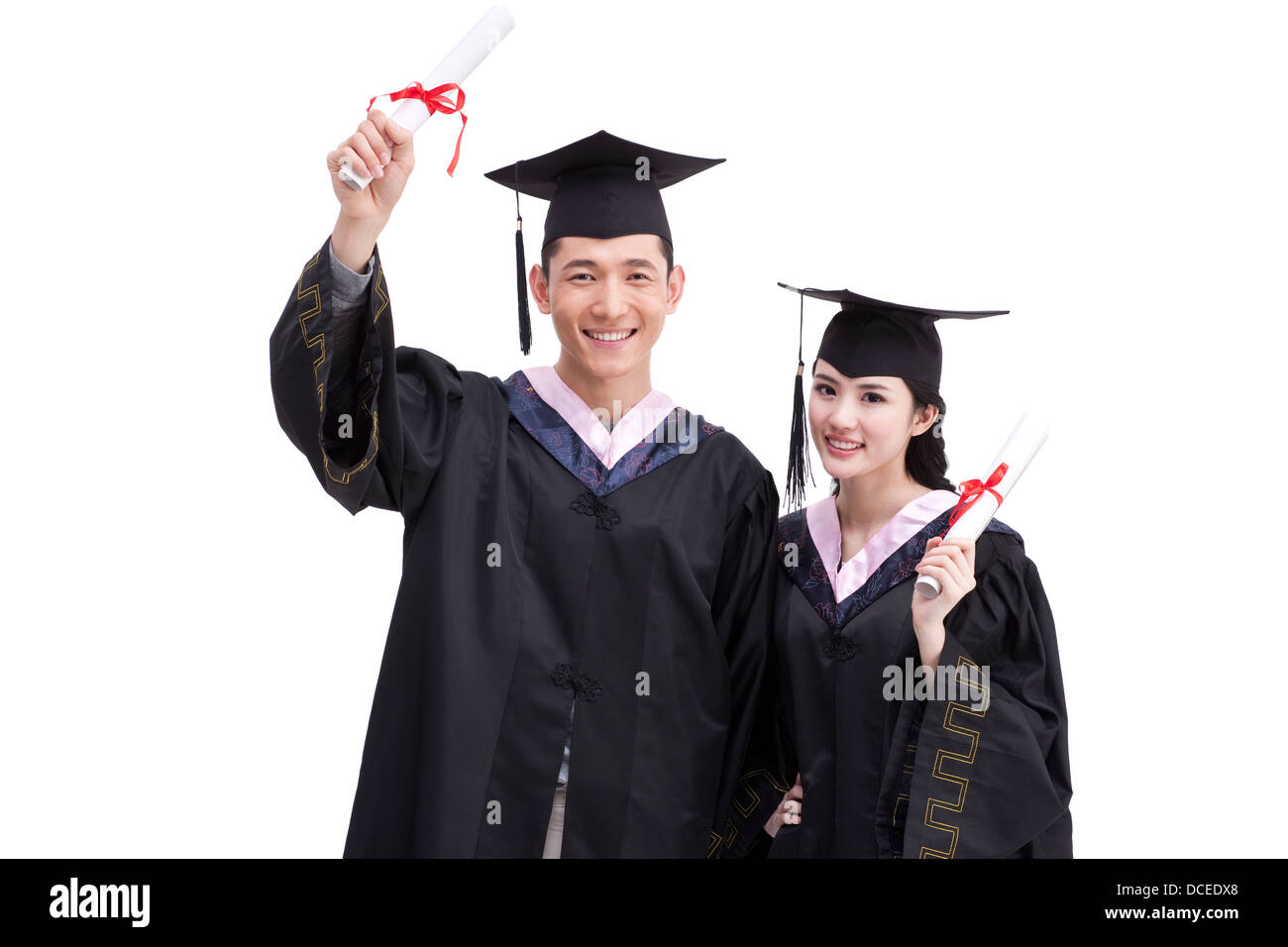 Happy college graduates in graduation gowns Stock Photo - Alamy