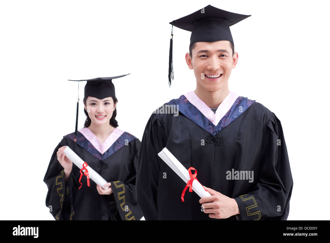Happy college graduates in graduation gowns Stock Photo - Alamy
