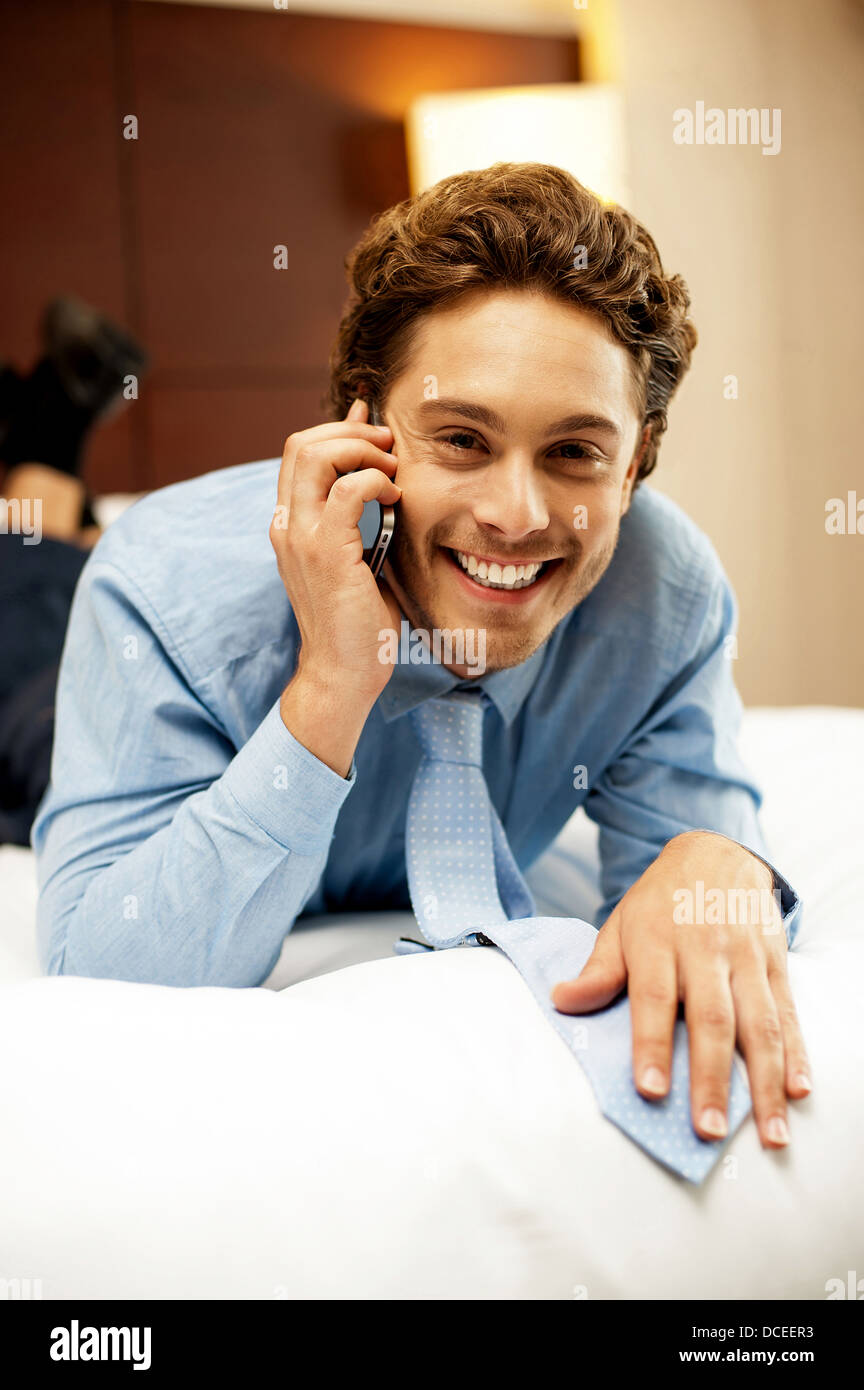 Relaxed young businessman communicating with his partner. Calm and cool ...