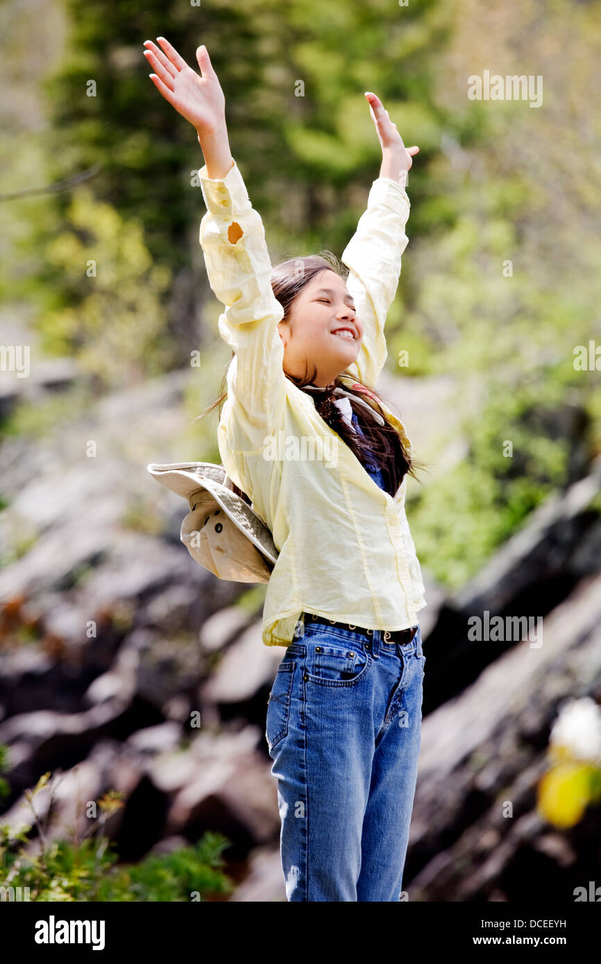 Girl raising hands in praise Stock Photo - Alamy