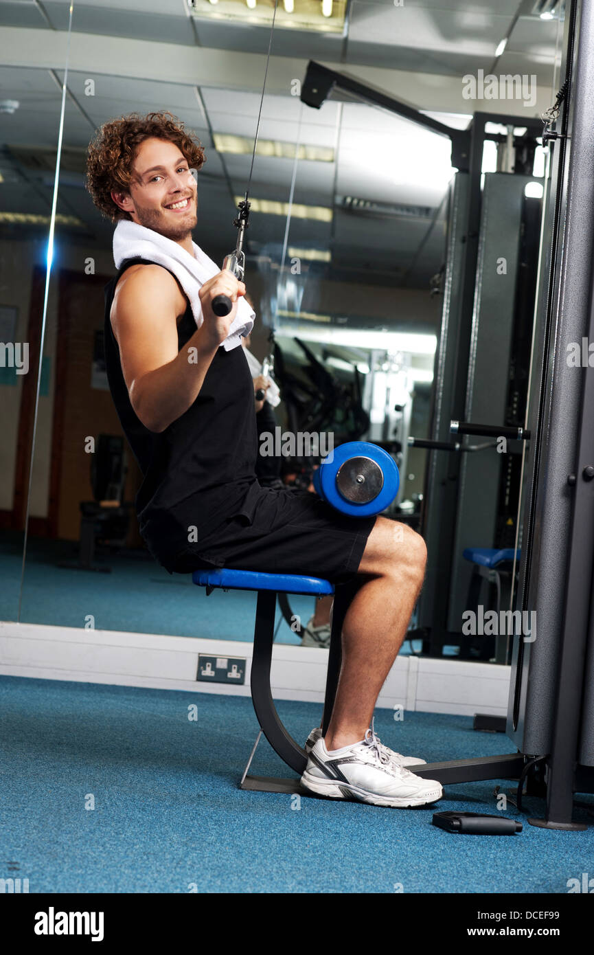 Handsome fitness guy working out in the fitness club Stock Photo - Alamy