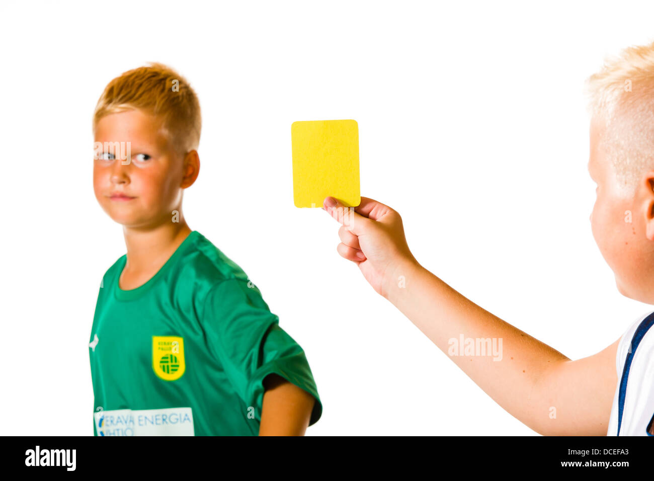 Young football player get yellow card, studio shot, white background ...