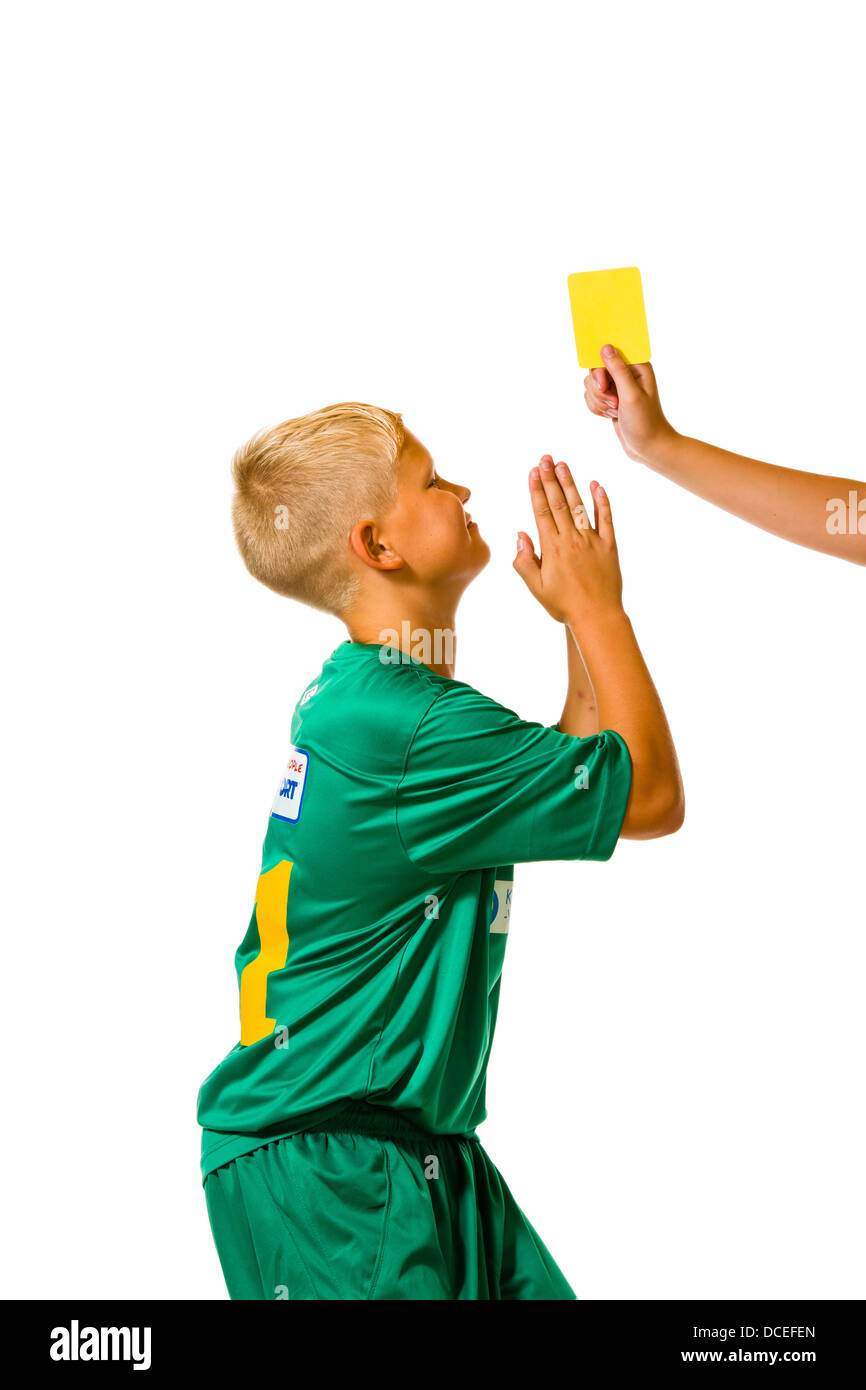 Young football player get yellow card, studio shot, white background ...