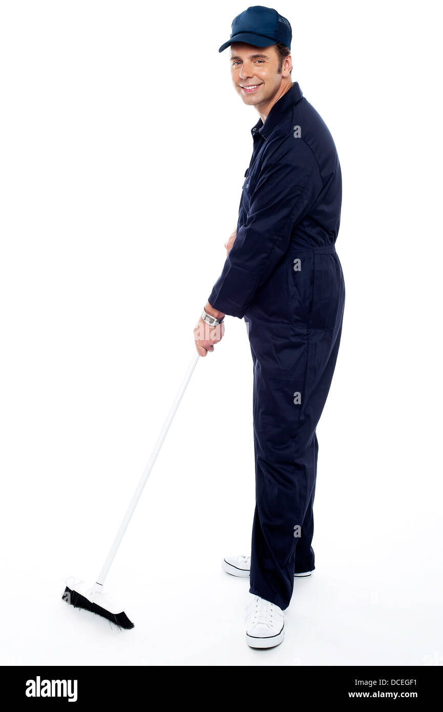 Professional cleaner in uniform wiping the floor. Studio shot Stock ...