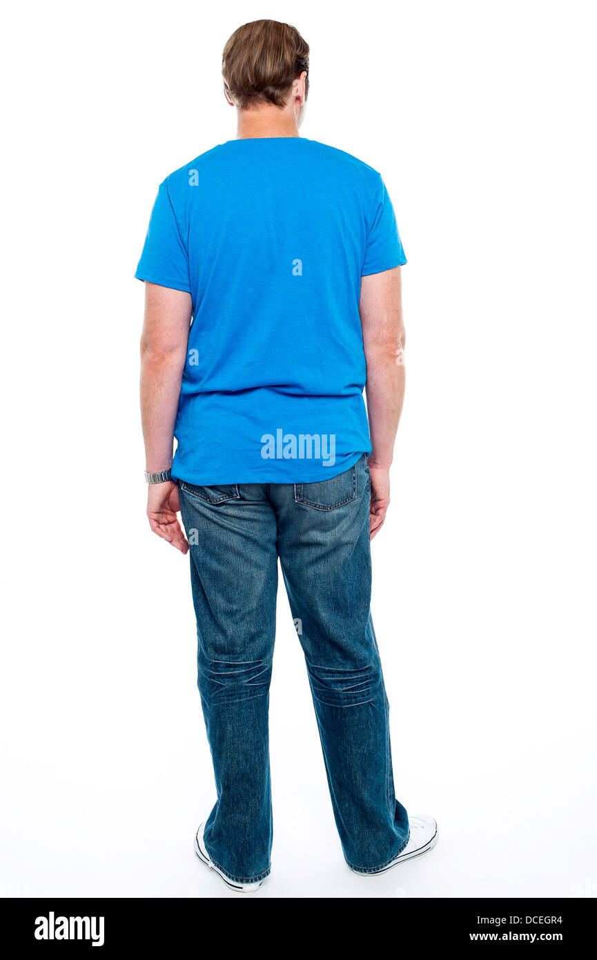 Rear view of casual young guy posing over white background Stock Photo ...