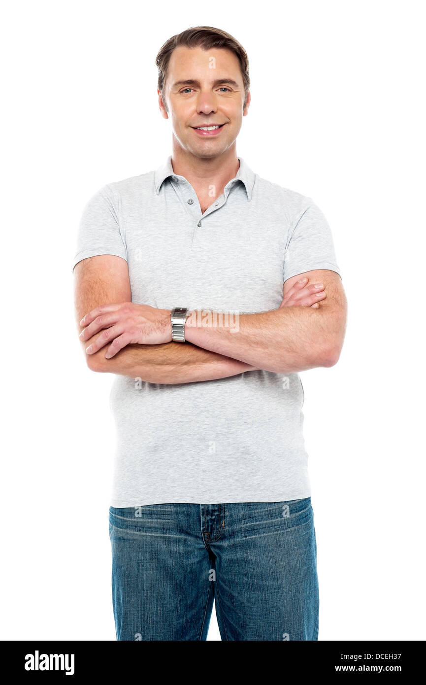 Joyous young man posing with his arms crossed isolated over white ...