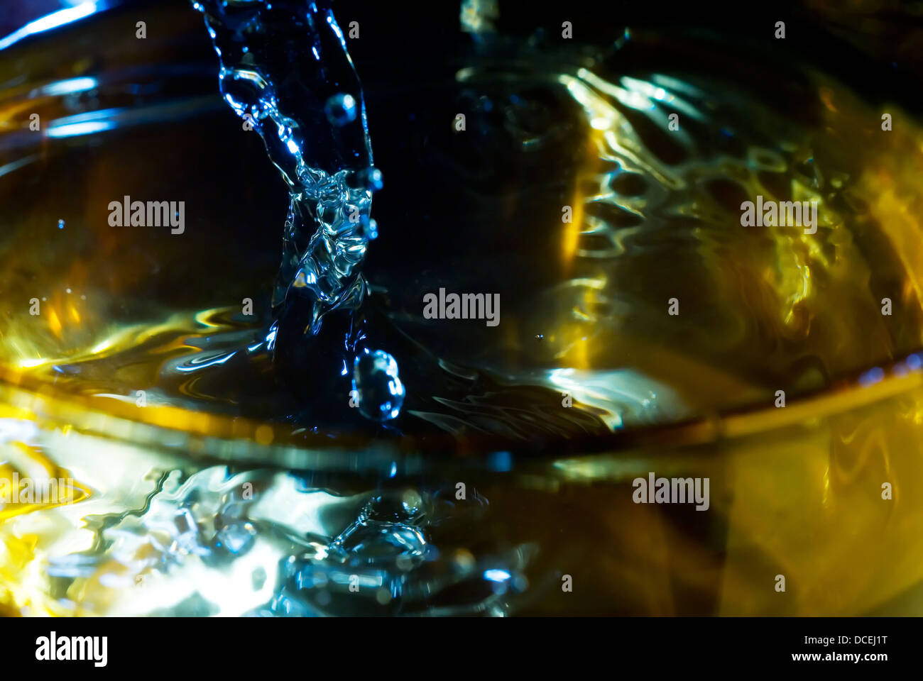 splash on clear glass with colored light Stock Photo - Alamy