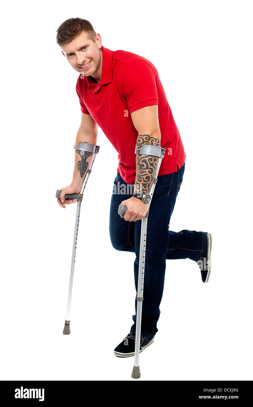 Young man recovering from severe accident. Walking with help of ...