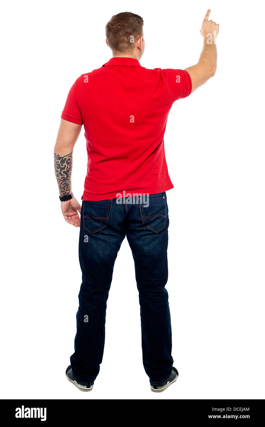 Back pose of man pointing at copy space area. Full length shot Stock ...