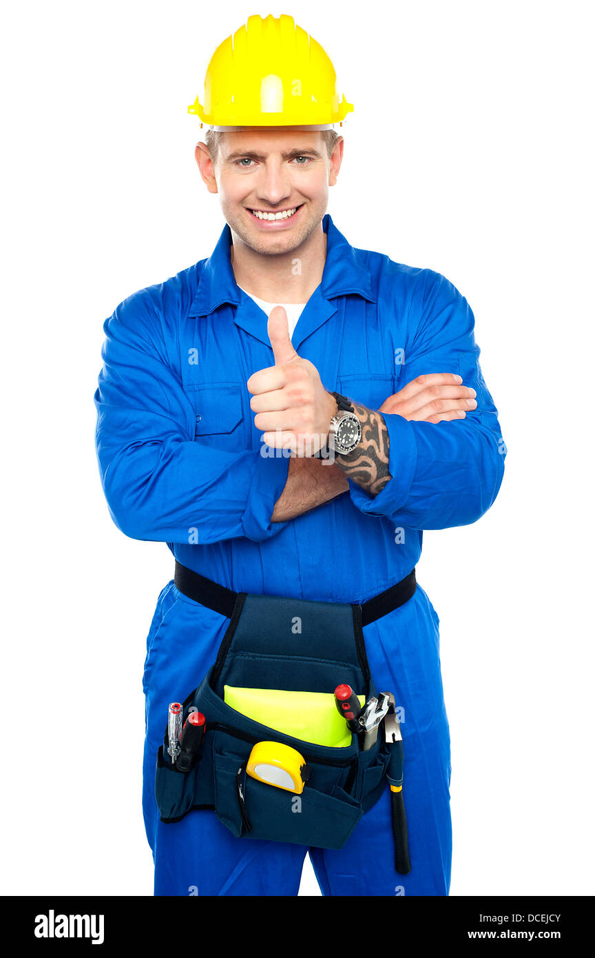 Smiling young industrial contractor showing thumbs up to camera Stock ...