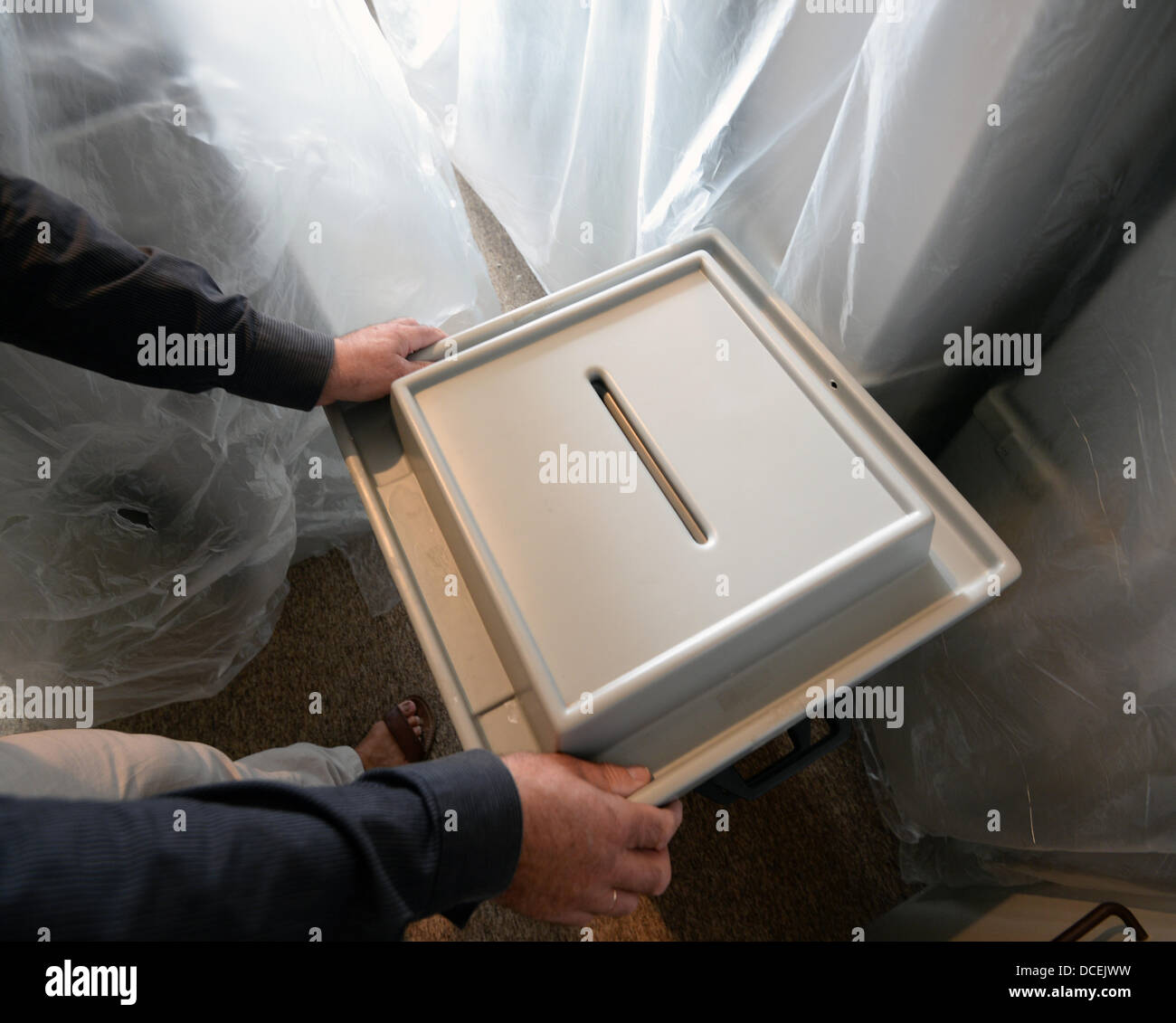 District election officer Andreas Foerster inspects the ballot boxes ...