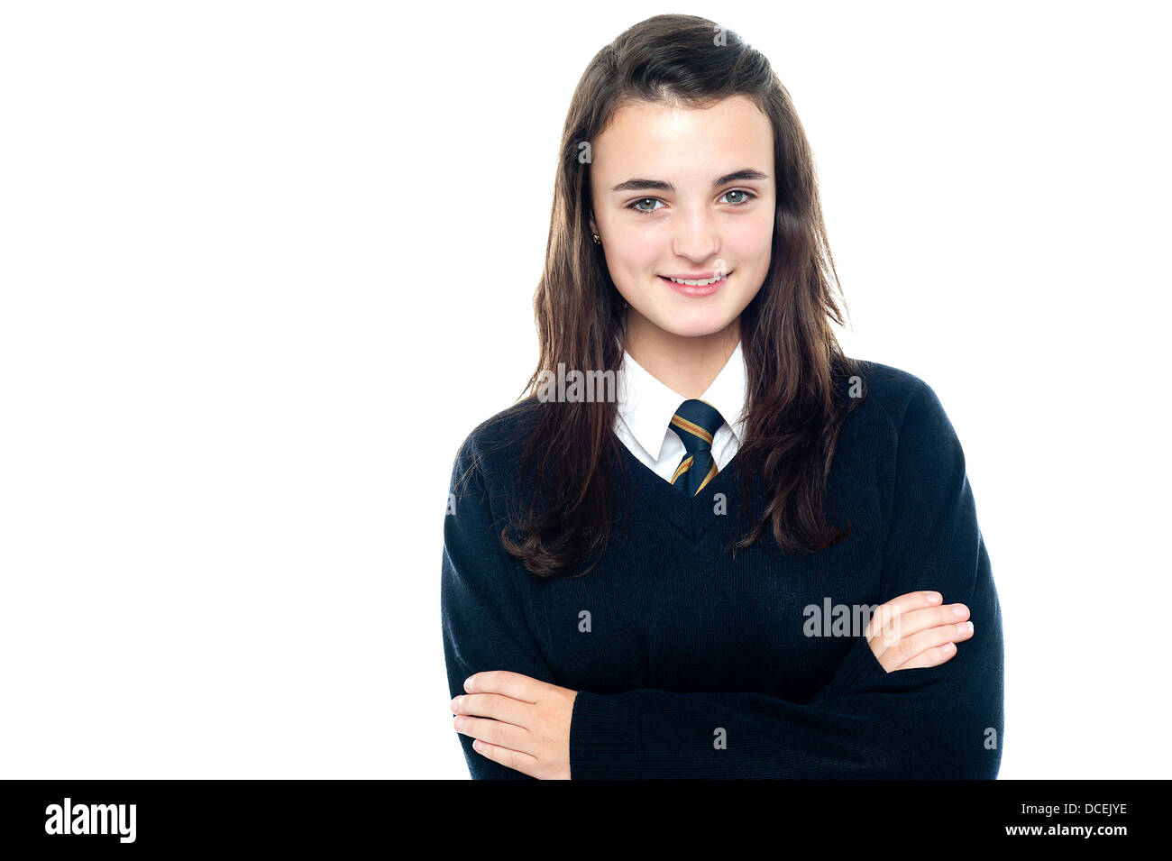 Confident young school child in uniform posing with folded arms Stock ...