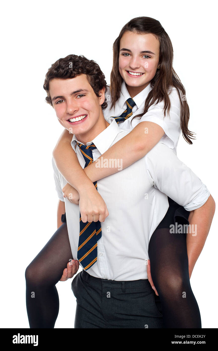 Cheerful shot of youngster riding piggyback in school uniform and ...