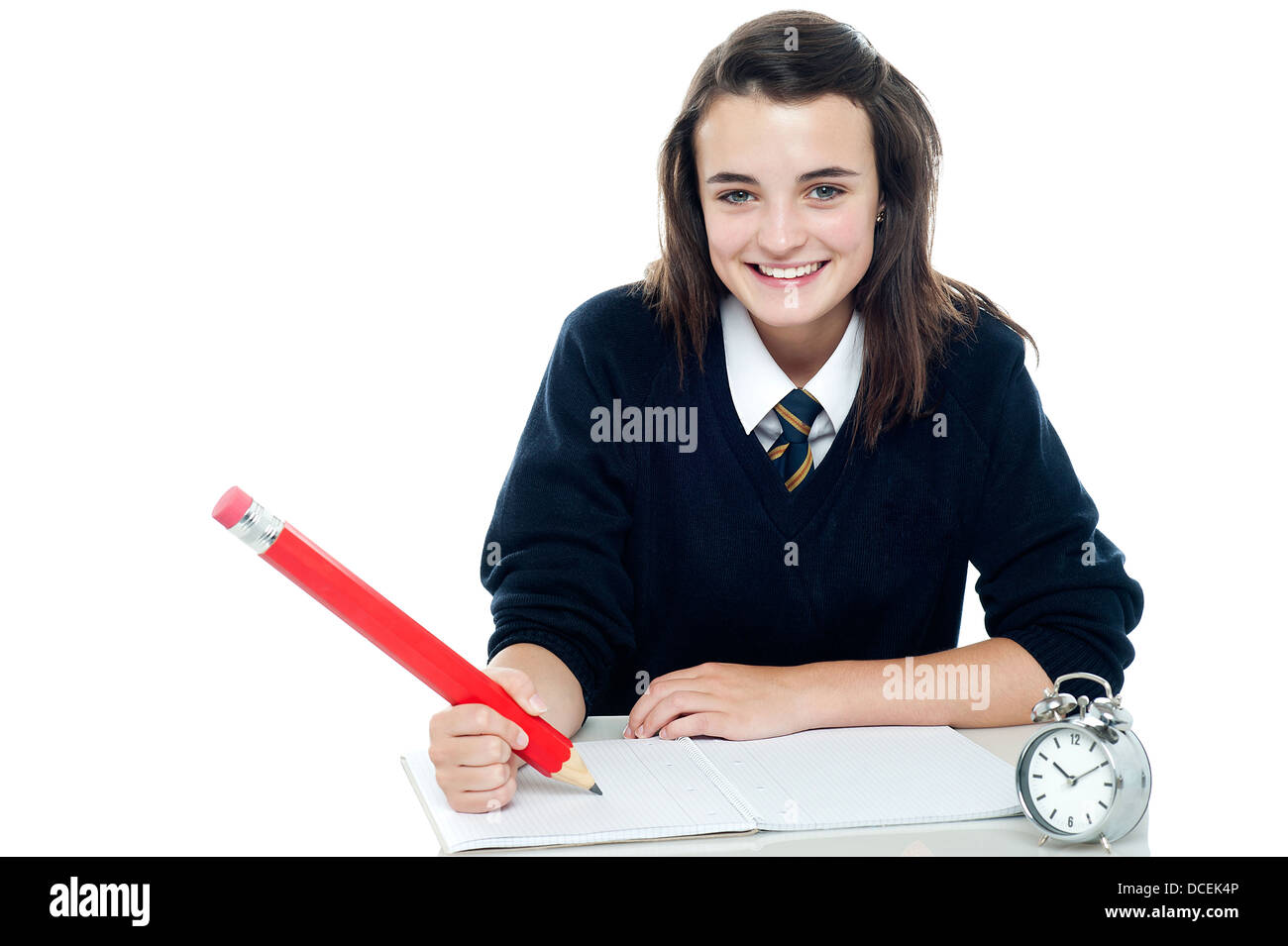 Profile shot of smiling school girl taking down notes, holding big red ...