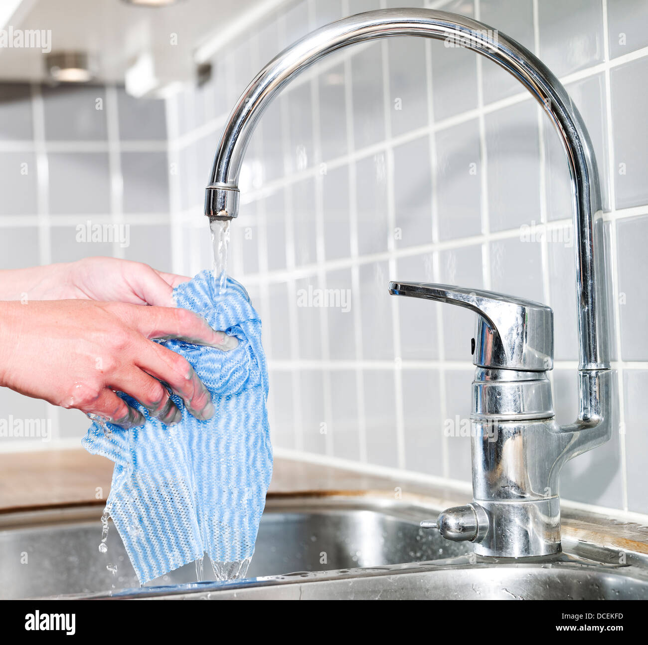Dish Cloth under running water Stock Photo - Alamy
