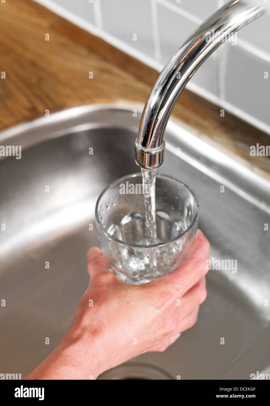Filling a glass of water Stock Photo - Alamy