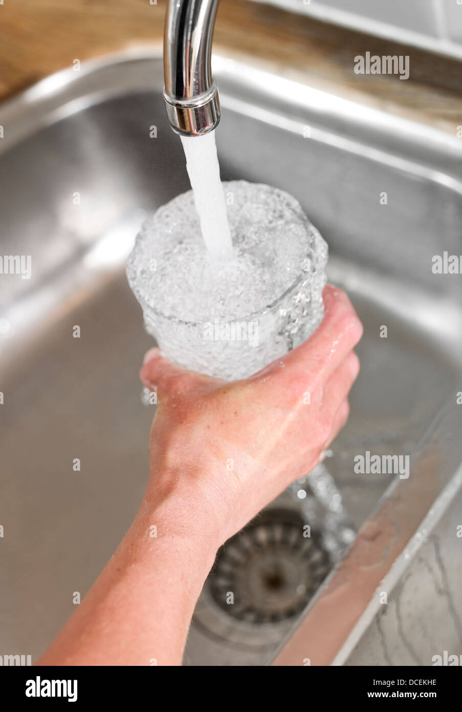 Filling a glass of water Stock Photo - Alamy