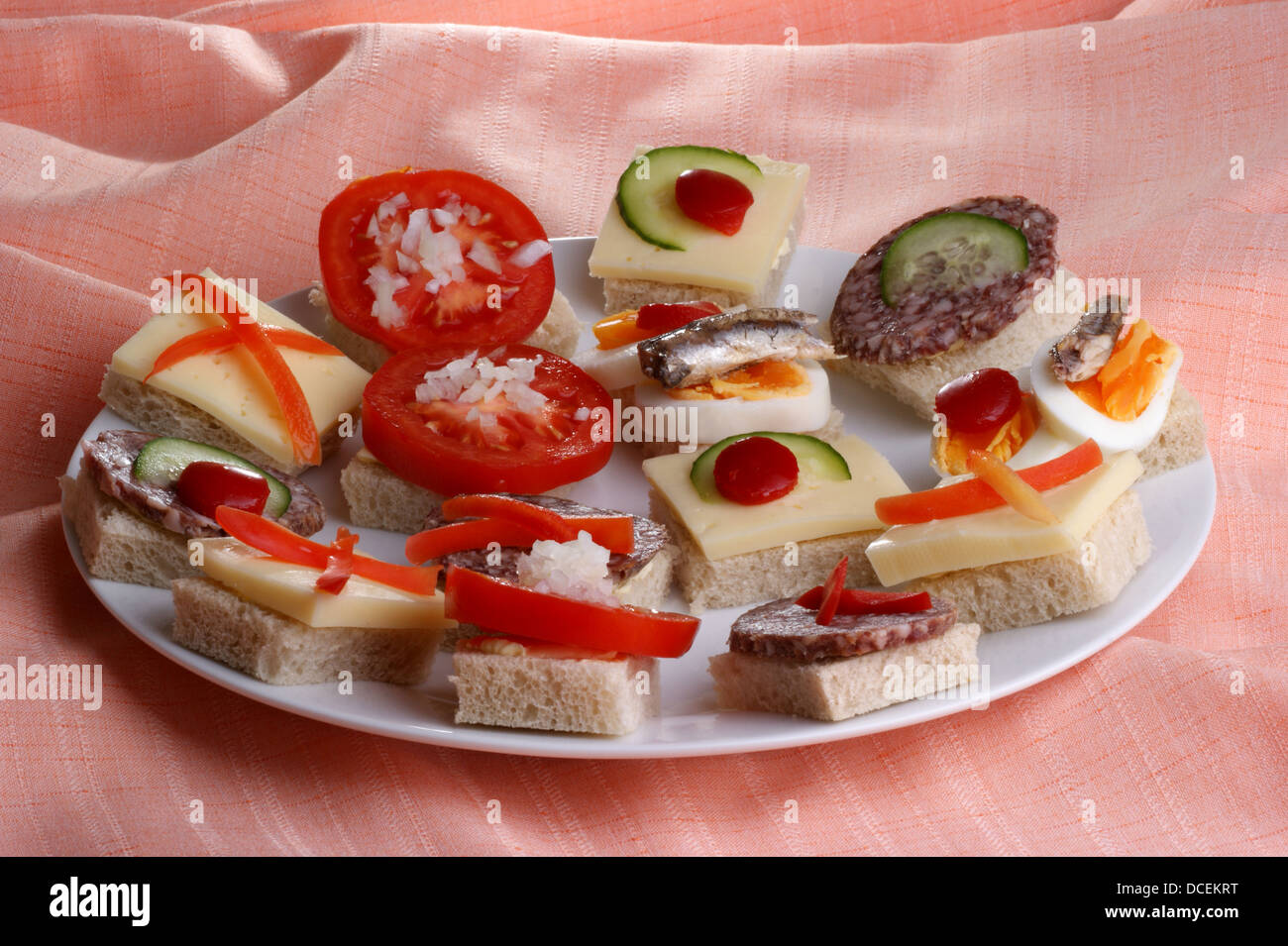 some party nibbles on a white plate Stock Photo - Alamy