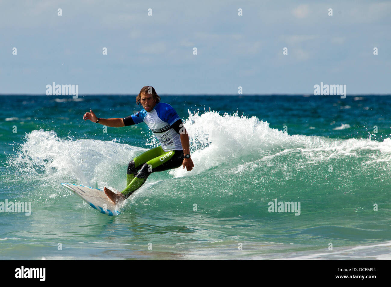 Adam Griffiths on the middle of a turn on a right wave in the middle of ...