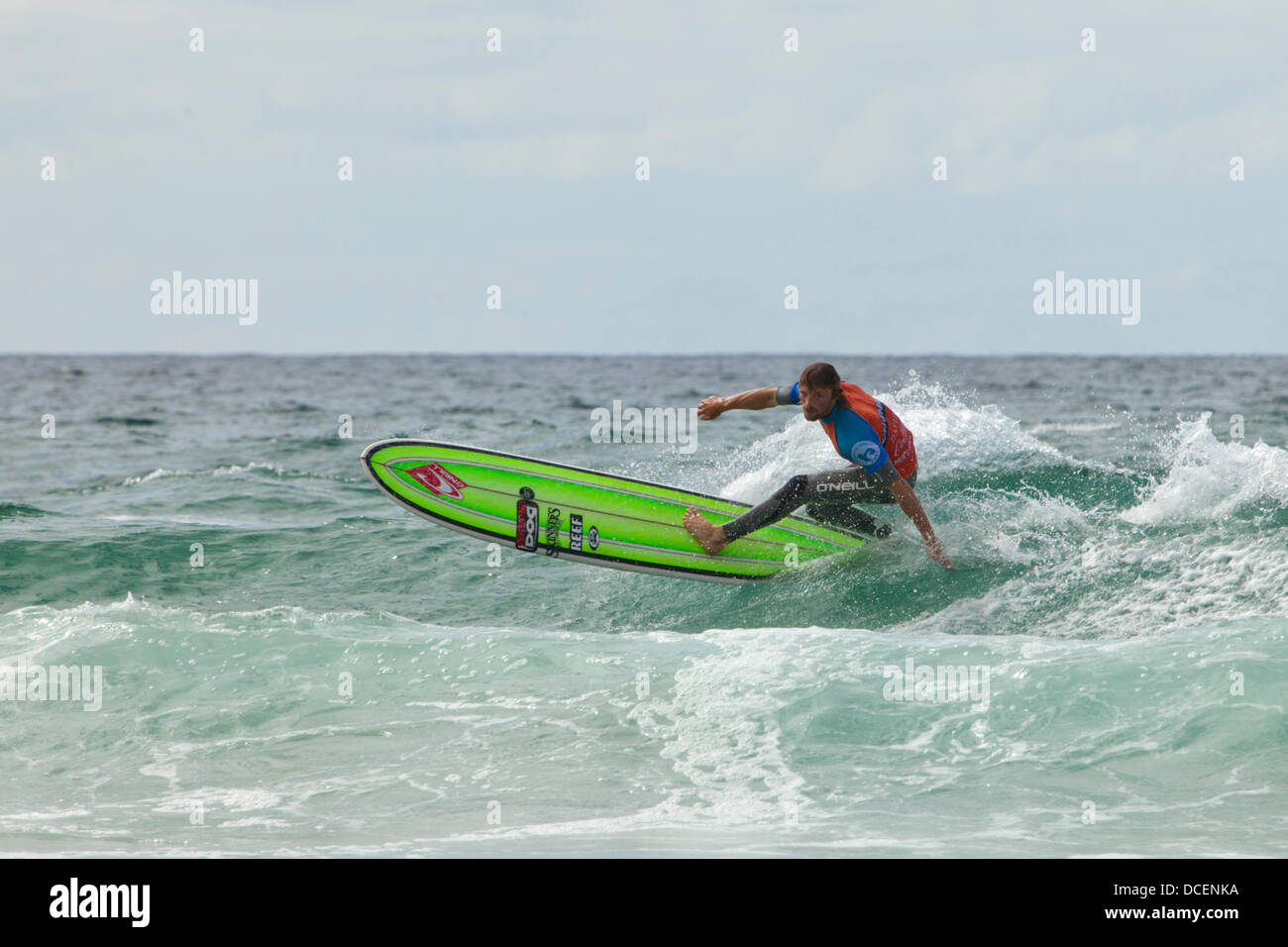 Wide angle Ben Skinner surfing a right wave at the back of the ...