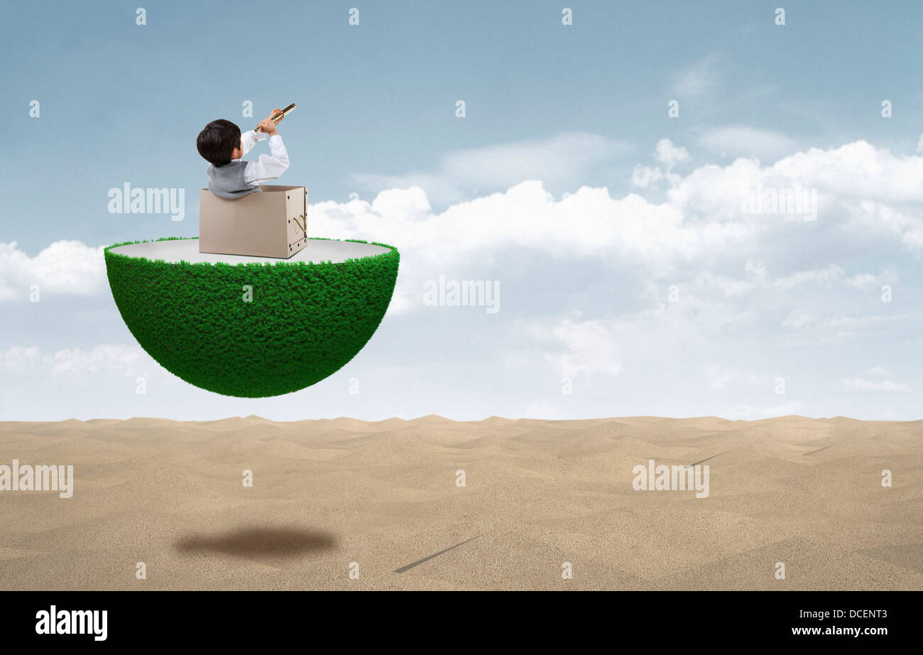 a boy in a box on floating land Stock Photo - Alamy