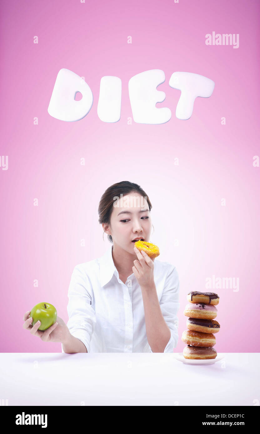 a woman eating diet food Stock Photo - Alamy