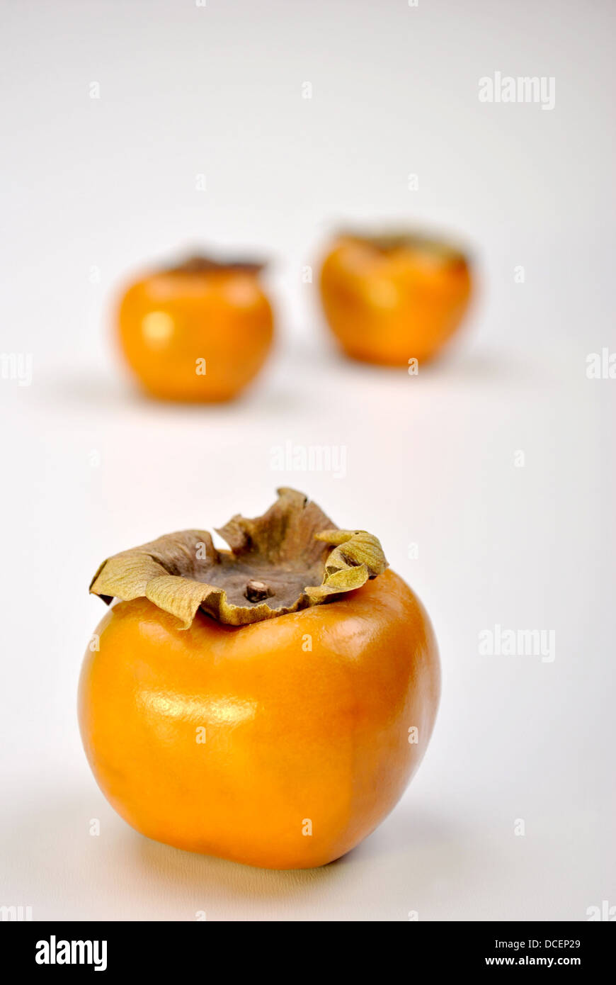 organic sharon fruit and a bright background Stock Photo - Alamy