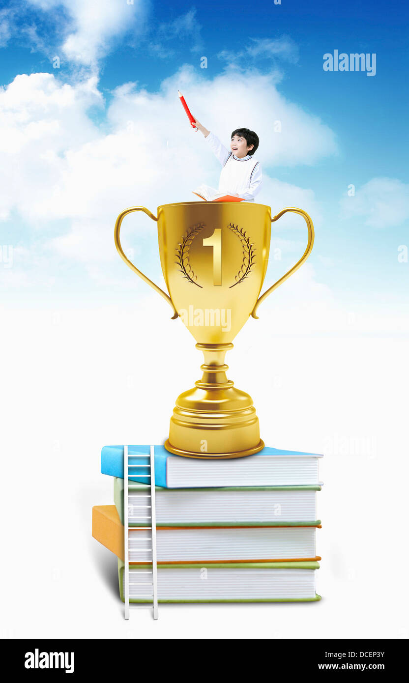 a kid inside a golden trophy Stock Photo - Alamy