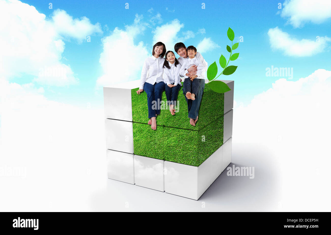 a family sitting on a cube Stock Photo - Alamy