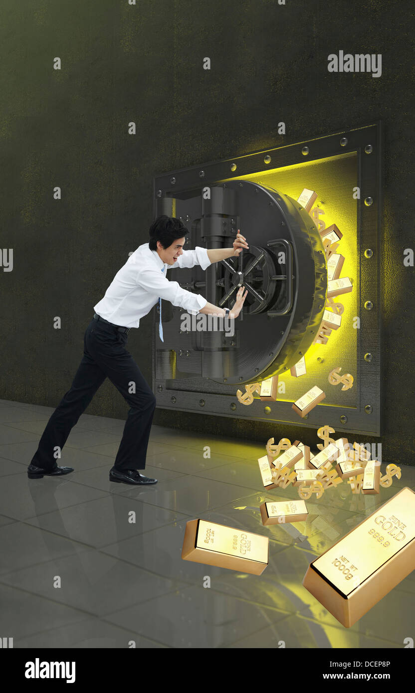a businessman locking a safe Stock Photo - Alamy